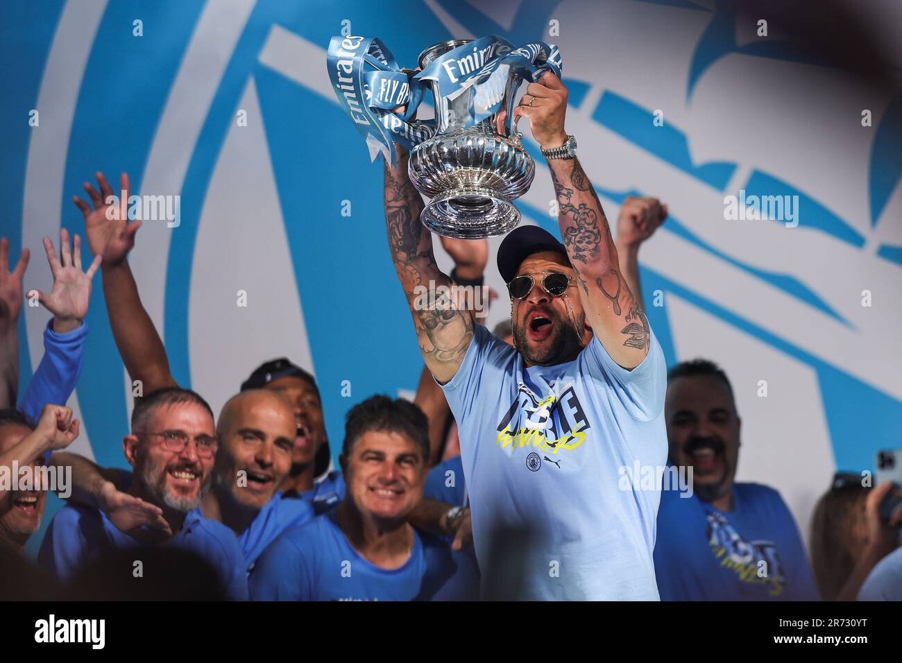 Kyle Walker #2 of Manchester City lifts the FA Cup on stage during ...