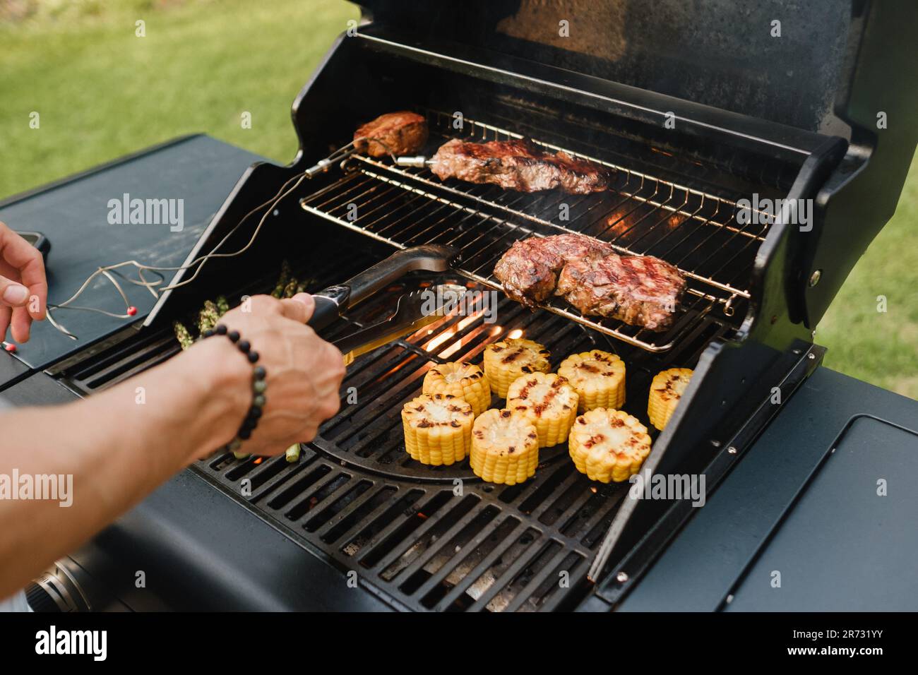 Cooking meat and vegetables on an outdoor grill Stock Photo - Alamy