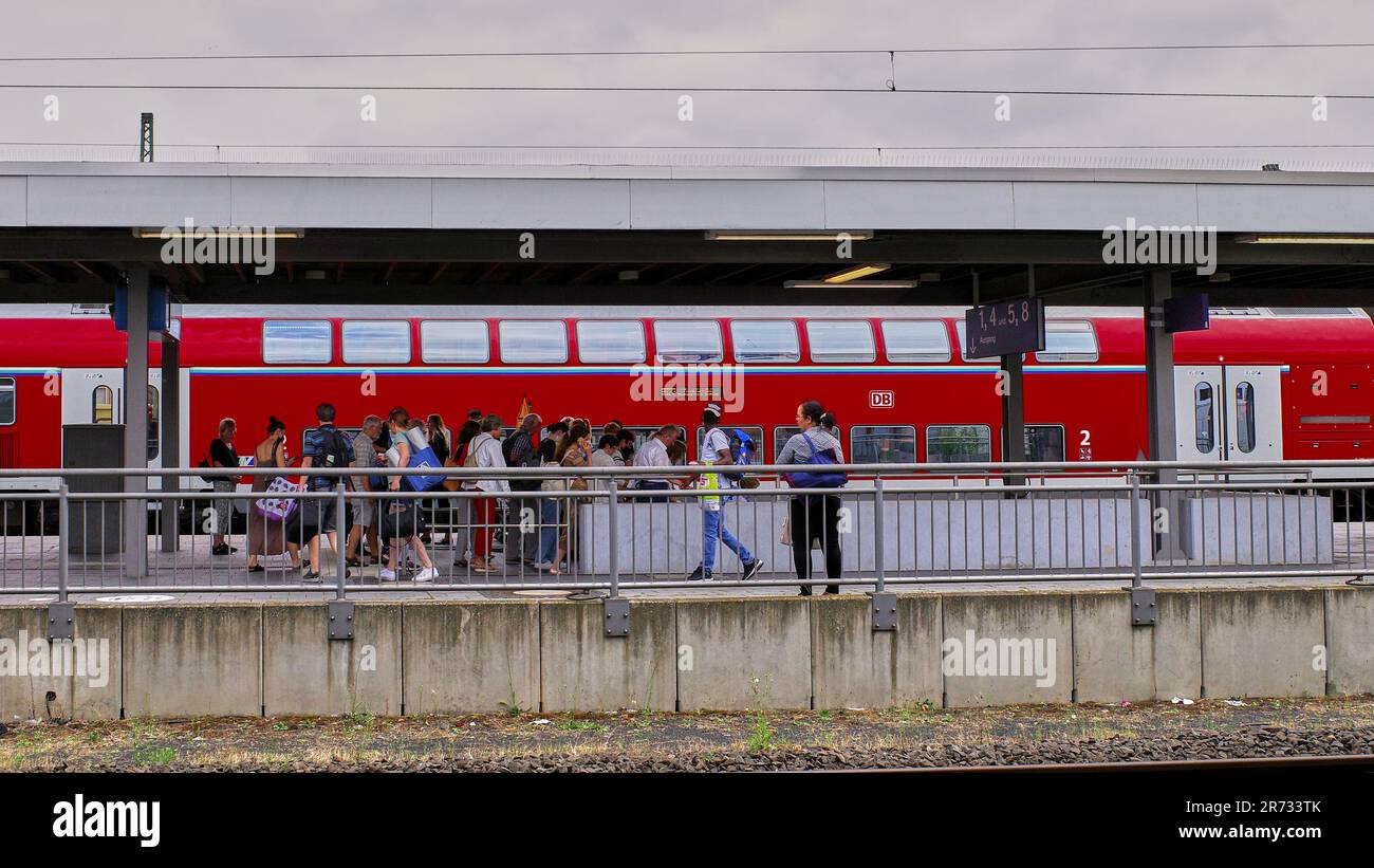 Deutsche Bahn train and travelers at the platform at one of the German ...