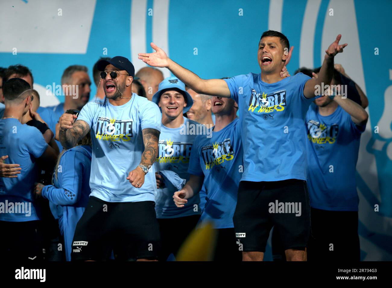 Manchester City's Kyle Walker (left) and Rodri celebrate on stage ...