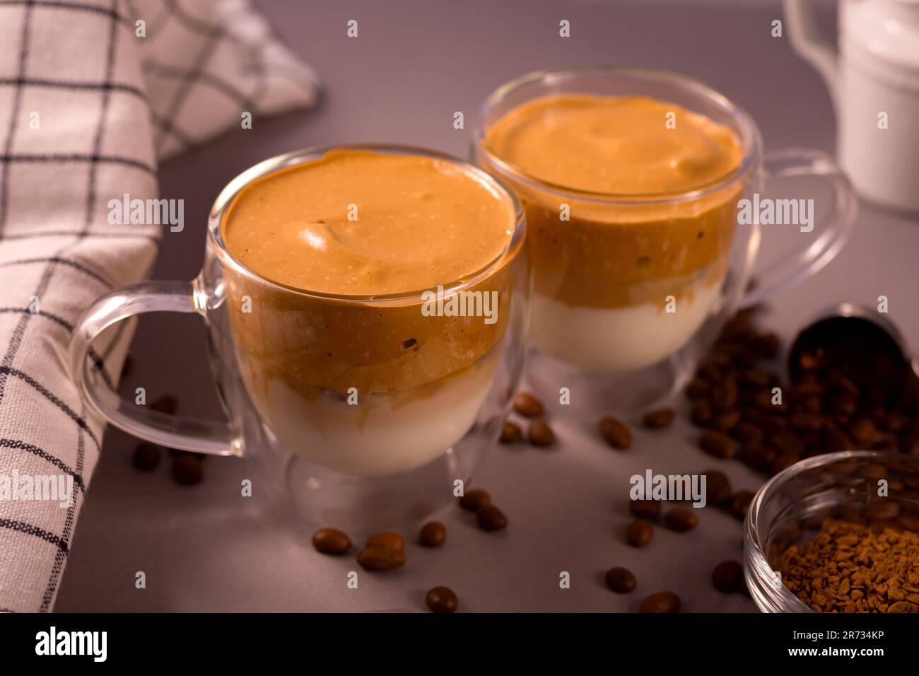 Transparent double wall glass mug with Dalgona Coffee. Whipped icing ...