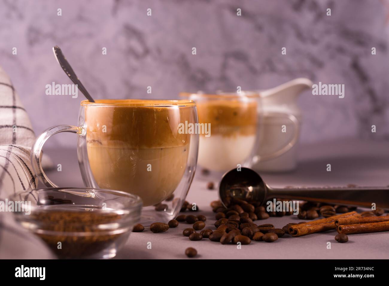Transparent double wall glass mug with Dalgona Coffee. Whipped icing ...