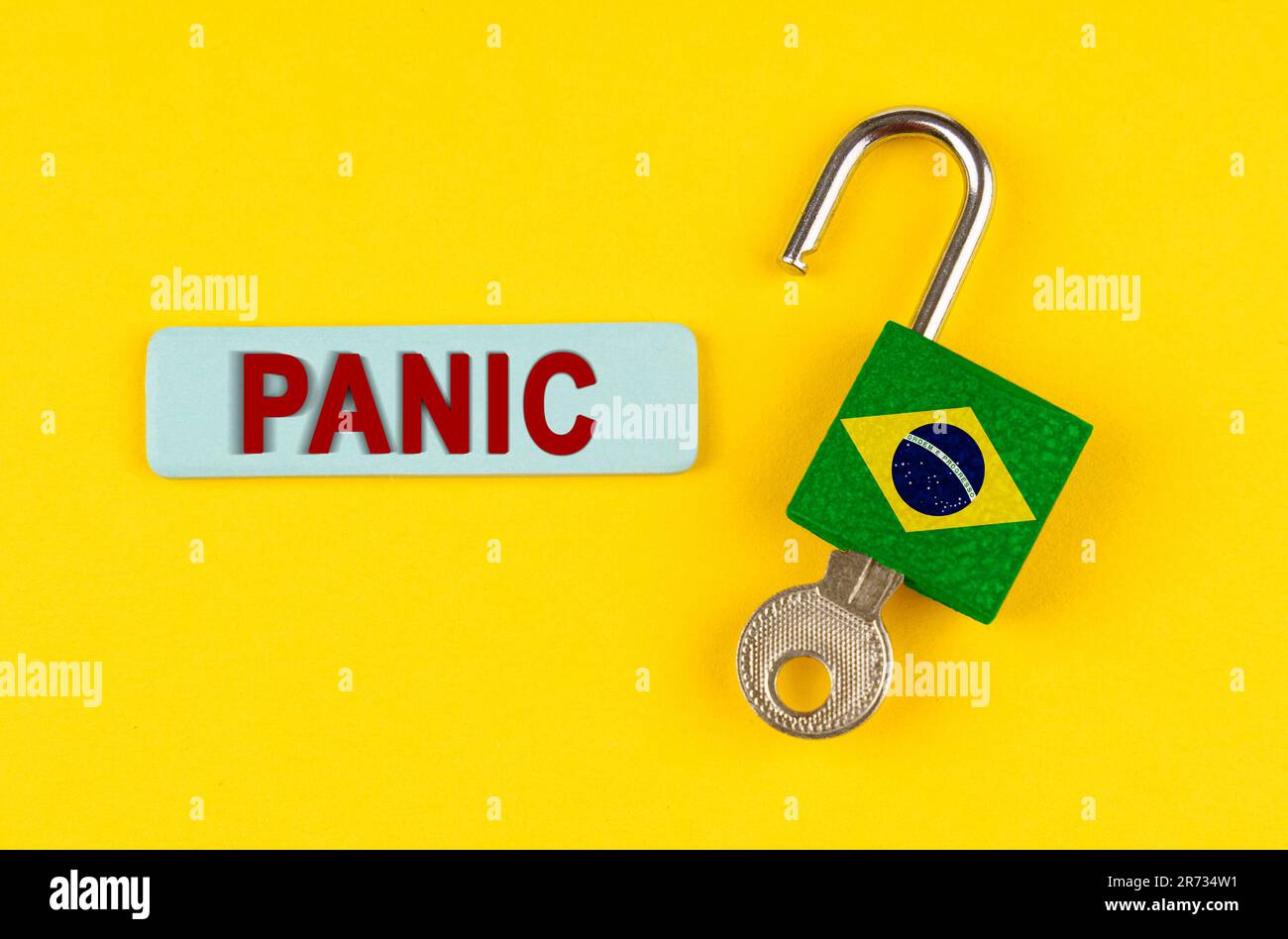 On a yellow surface, an open lock with the image of the flag of Brazil ...