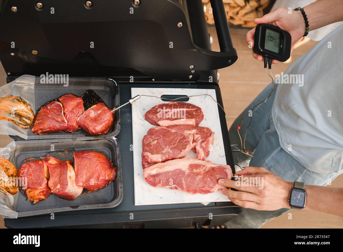 Preparation for Cooking meat on an open grill with temperature check ...