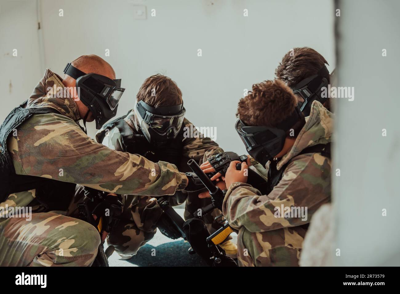 The paintball team agrees on tactics before the fight begins. Selective ...