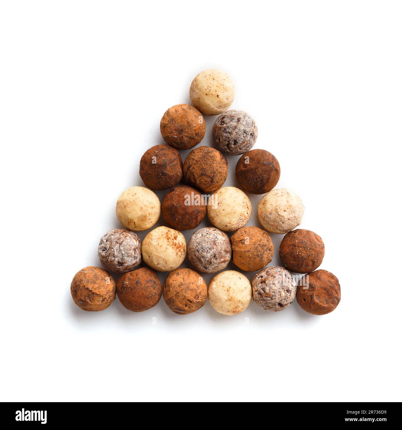 Round sweets truffles made of milk, black and white chocolate stacked ...