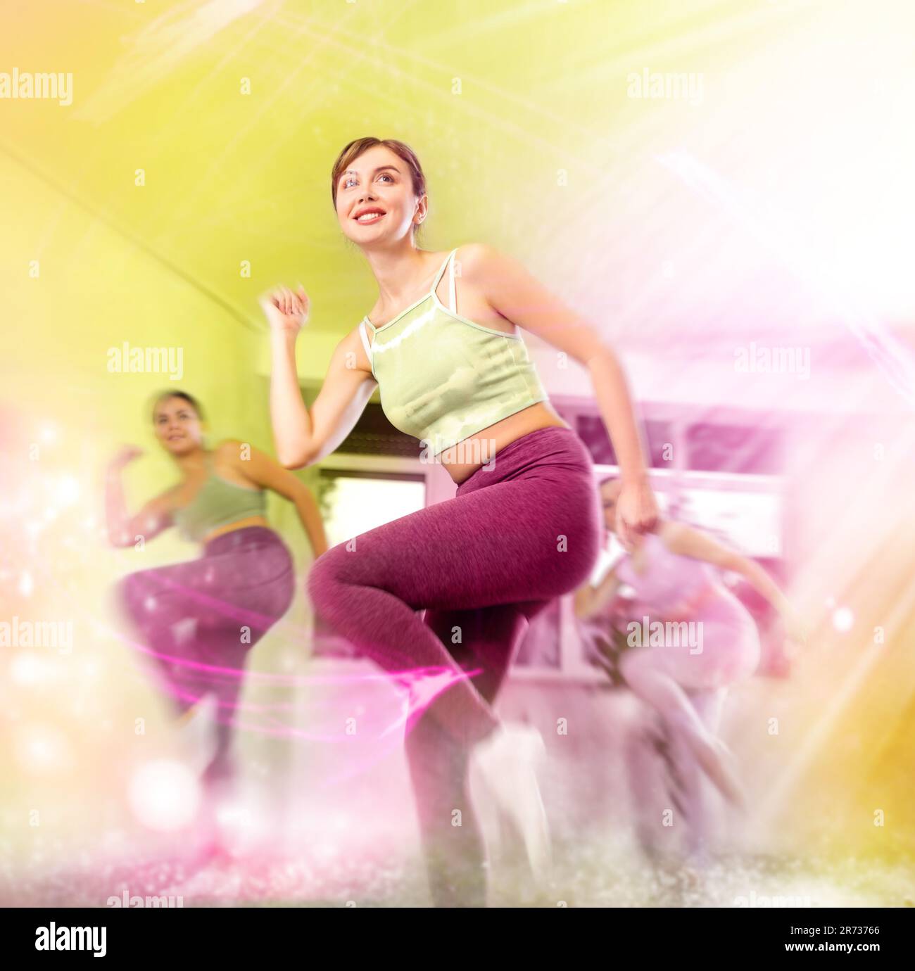 Positive women engaged in active dancing Stock Photo - Alamy