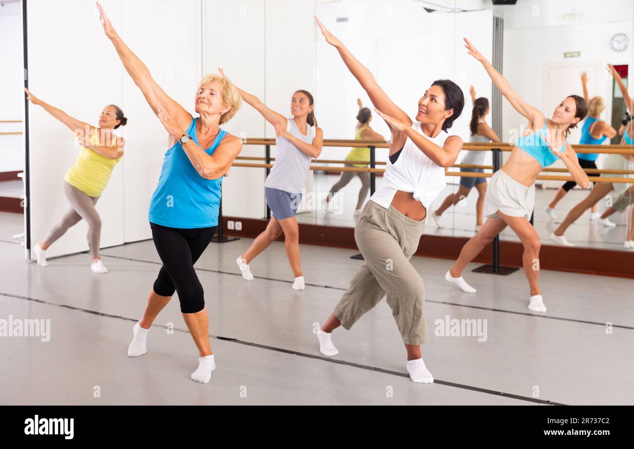 Group of active women practicing energetic dance in a studio Stock ...