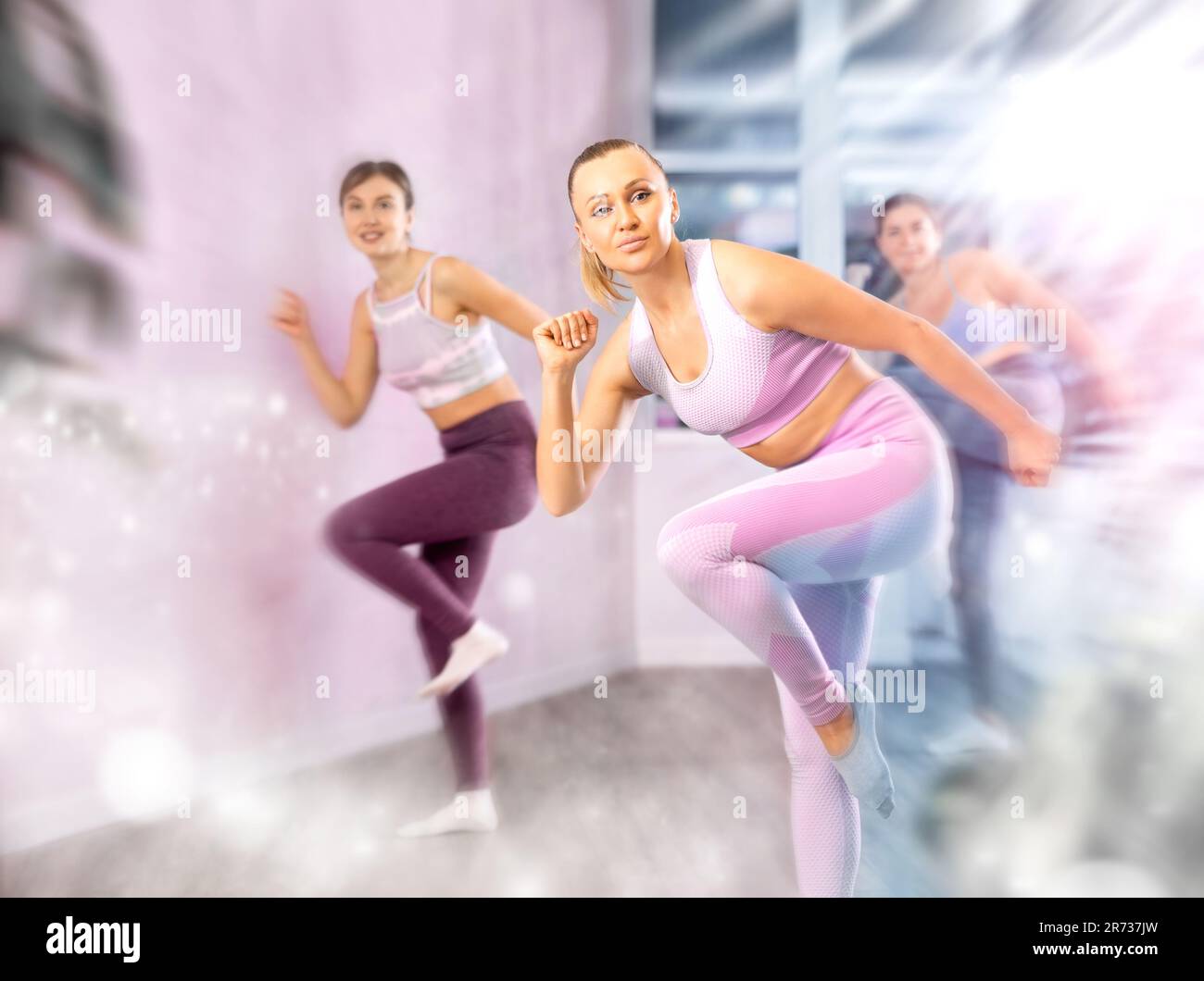 Positive women engaged in active dancing Stock Photo - Alamy
