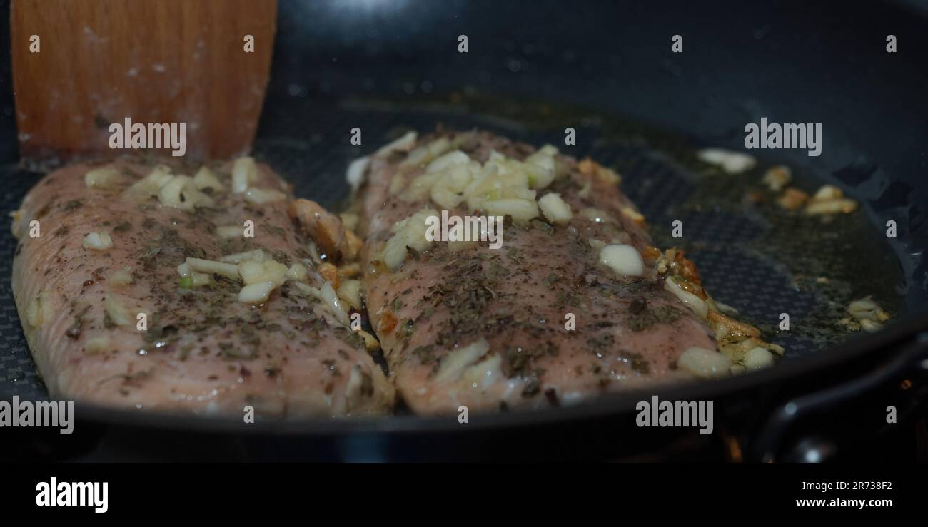 Cooking salmon into a pan for lunch in germany Stock Photo - Alamy