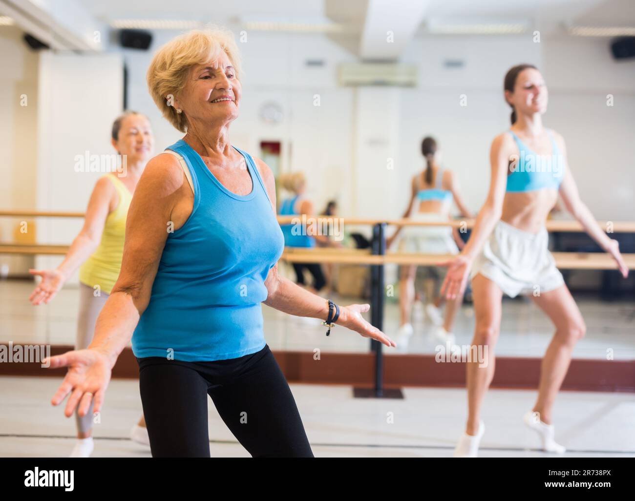 Old lady dancing with group in studio Stock Photo - Alamy
