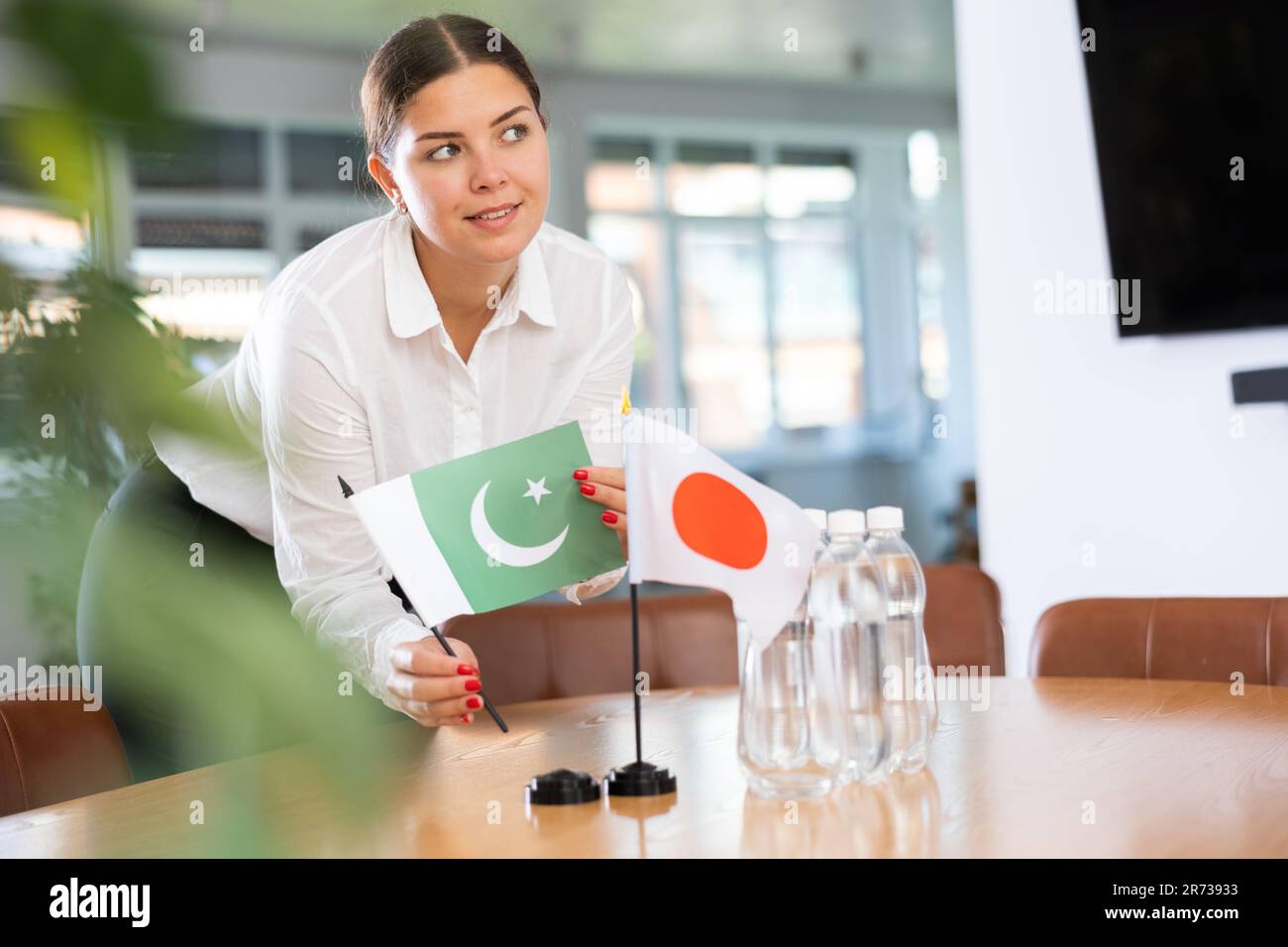 Female coordinator preparing office for Japanese-Pakistani ...