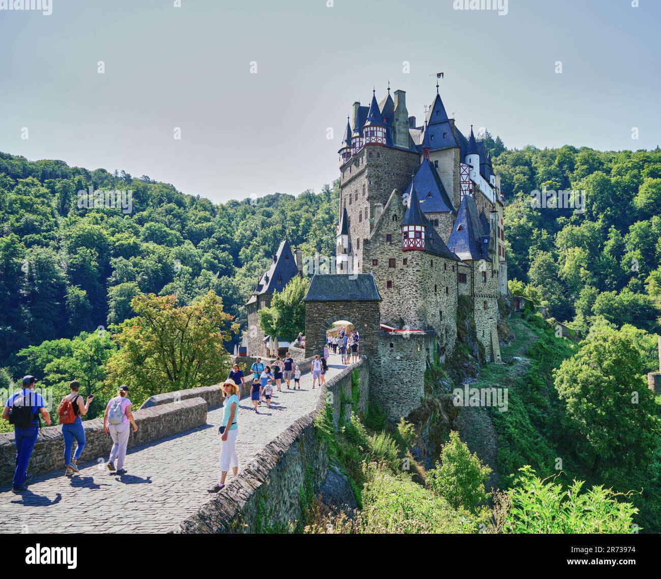 Fairytale Burg Eltz Castle with tourists walking the entrance stone ...