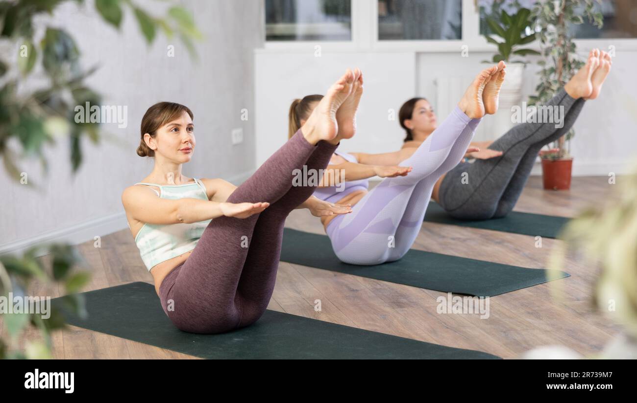 Group of active women practice various yoga poses Stock Photo - Alamy