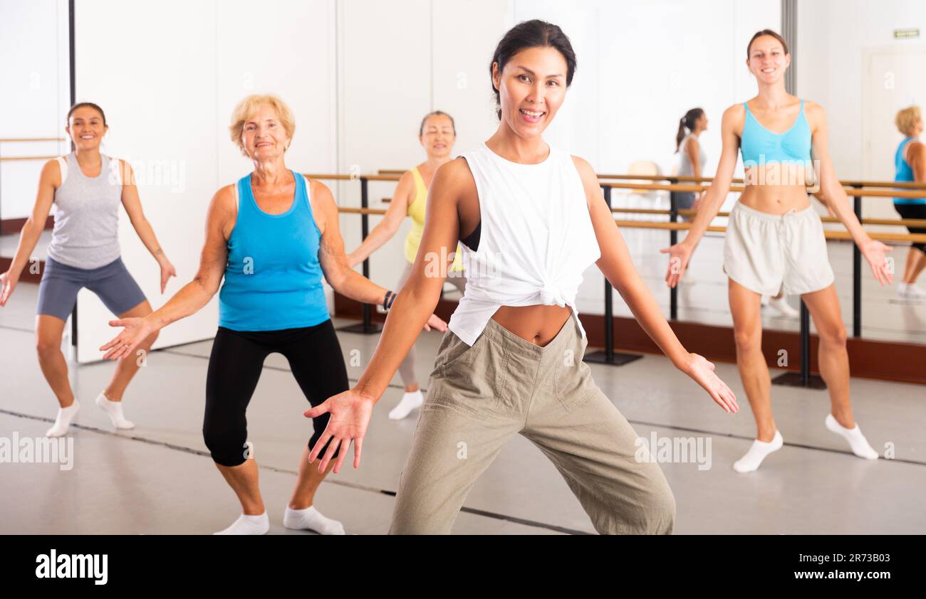 Positive asian woman practices energetic swing in a dance studio Stock ...