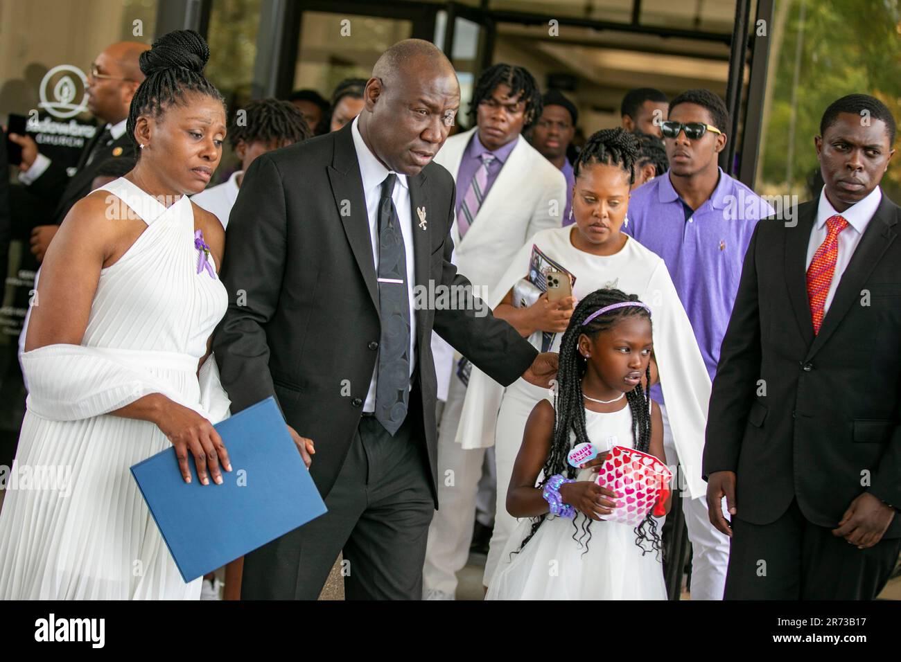 Pamela Dias, the mother of Ajike Owens, left, attorney Ben Crump and Africa Owens leave after ...