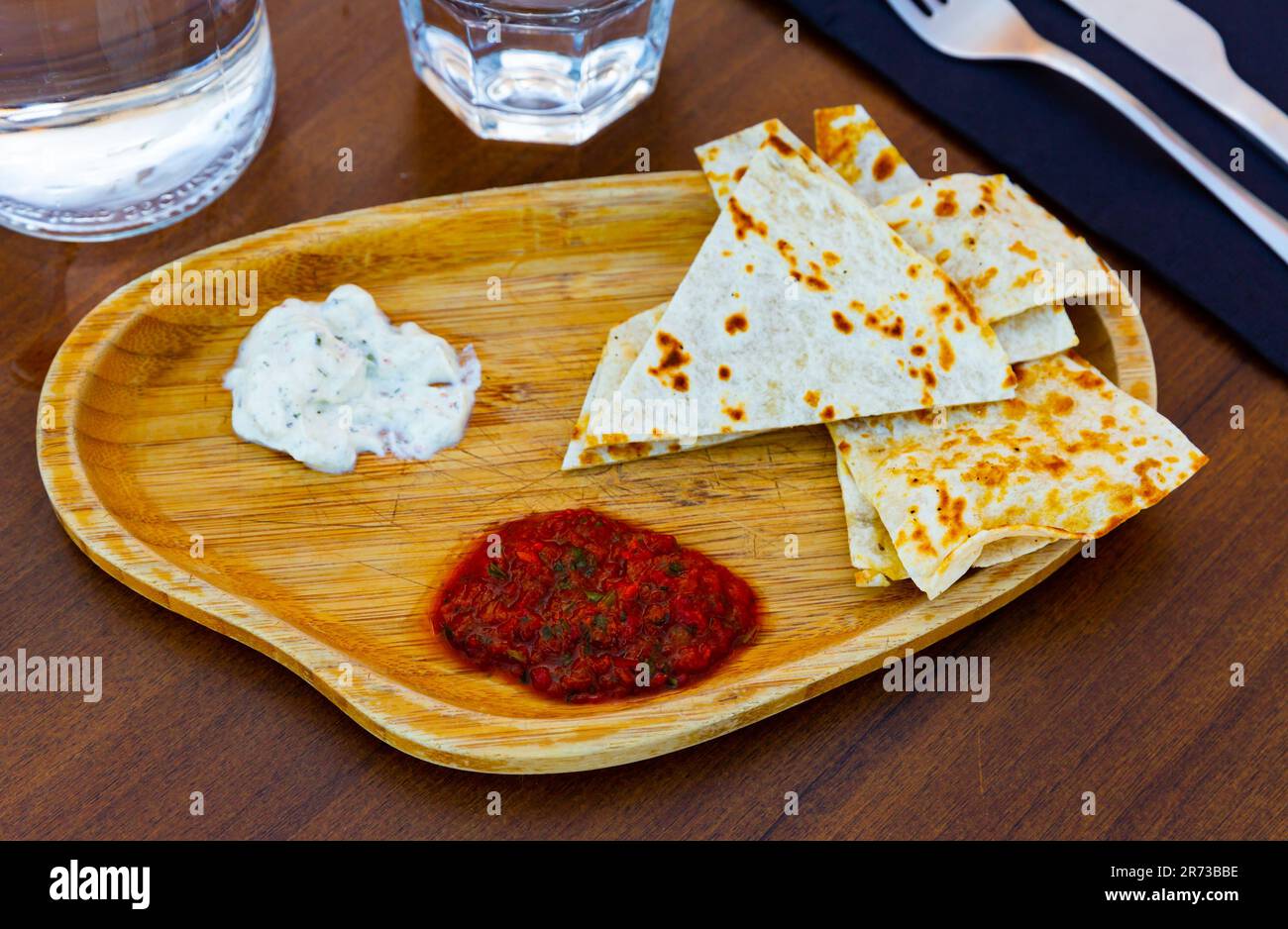 Popular Arabic appetizer made of pita bread with adjika and sauce Stock ...