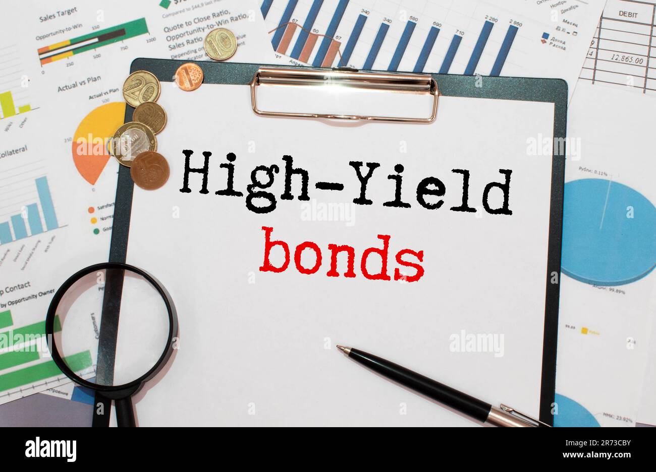 Business concept. On the financial charts lies a pen and a sign with the inscription - high ...