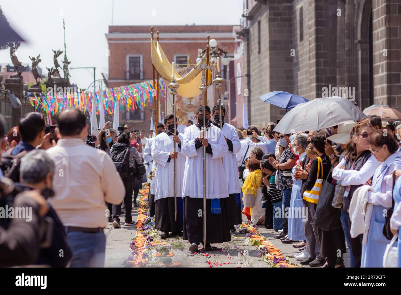 Priests and members of the Catholic church perform a procession in ...
