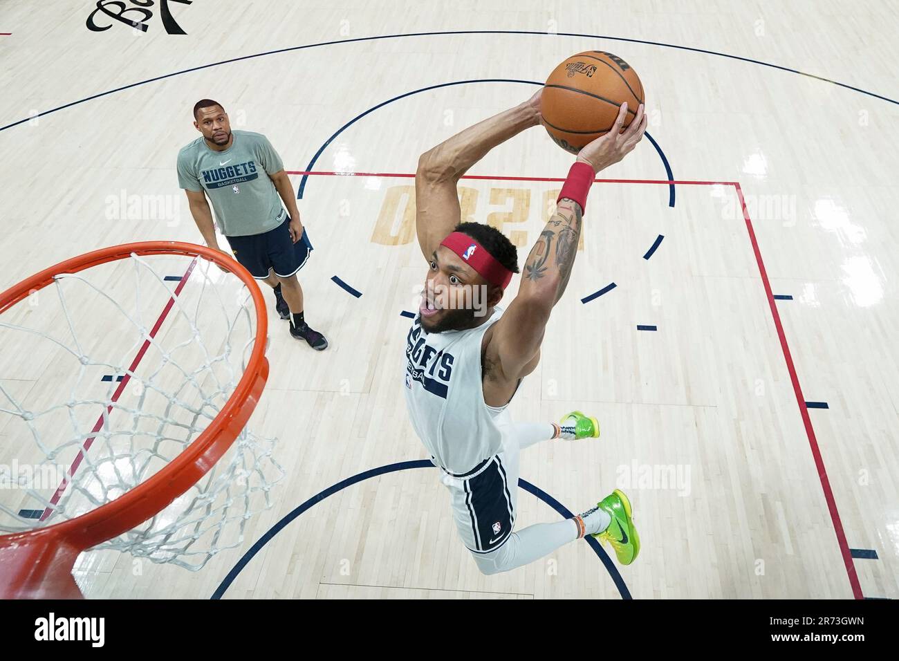 Denver Nuggets forward Bruce Brown, right, dunks during warmups before ...