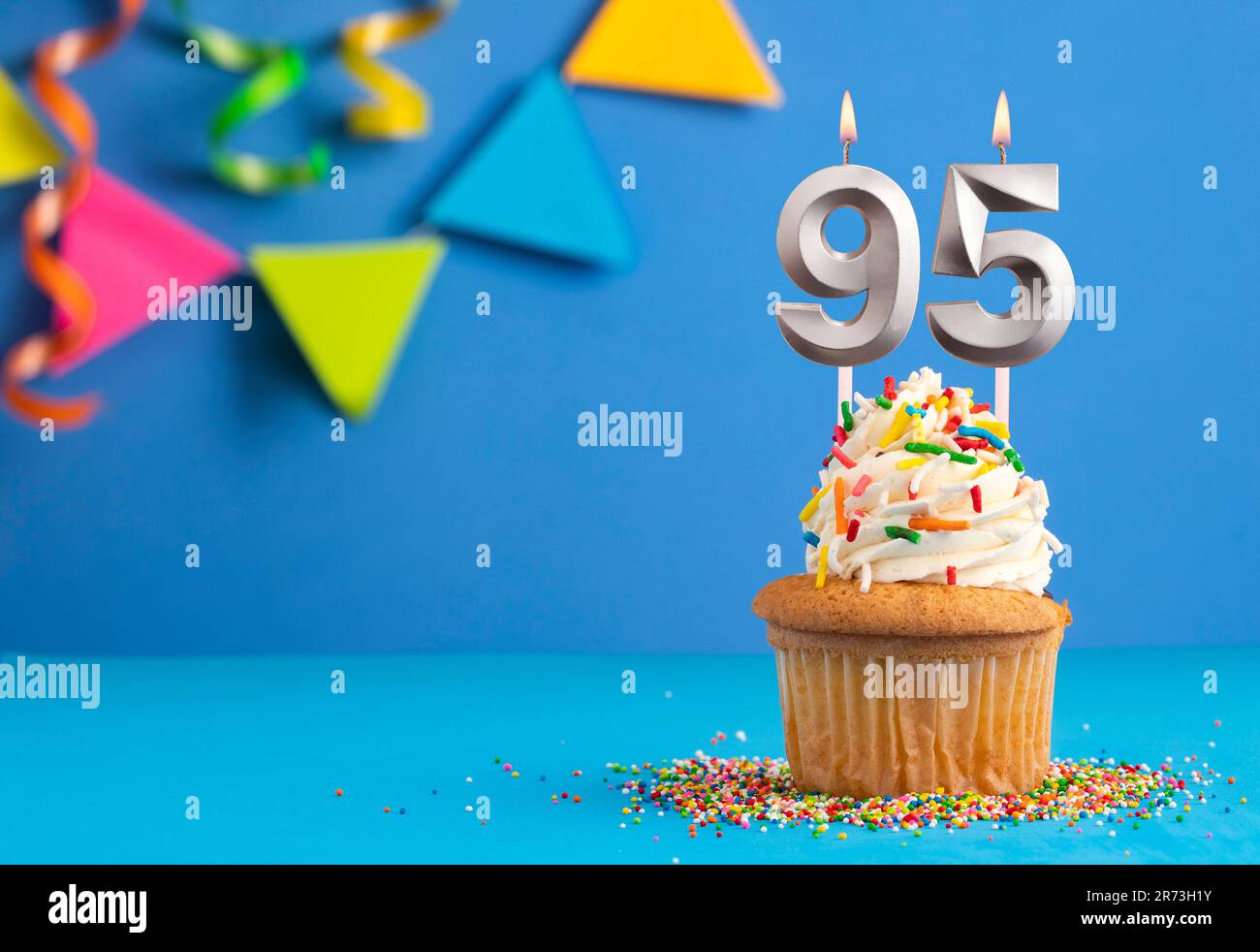Birthday cake with candle number 95 - Blue background Stock Photo - Alamy