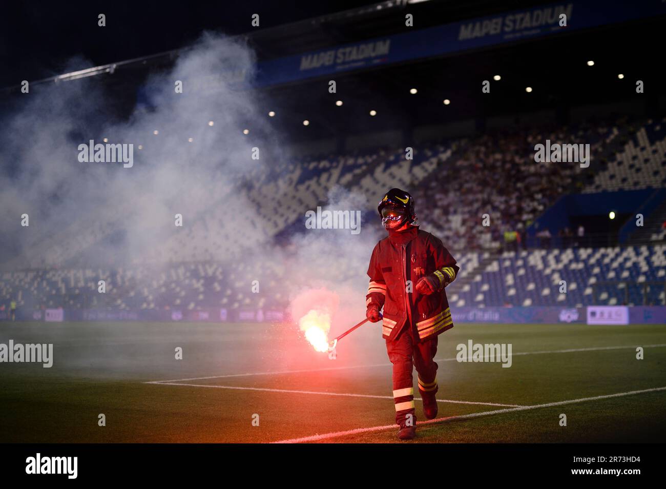 Reggio Emilia, Italy. 11 June 2023. A firefighter picks up a smoke bomb ...