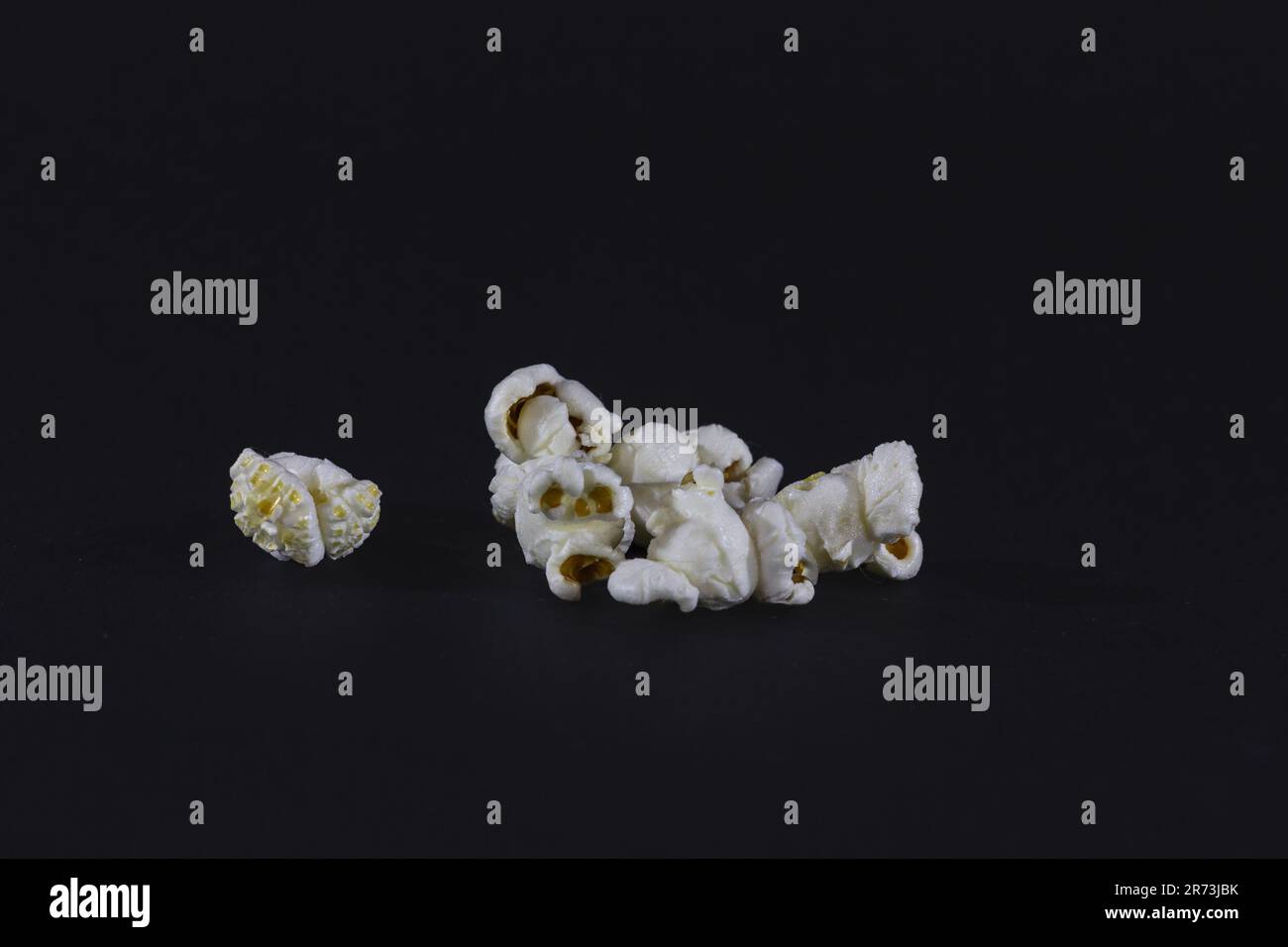 Picture of isolated white popcorn on black background. Popcorn is a ...