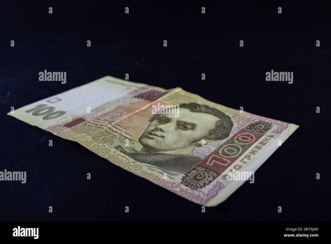 Picture of a ukrainian banknote of 100 hryvnia isolated on a black ...