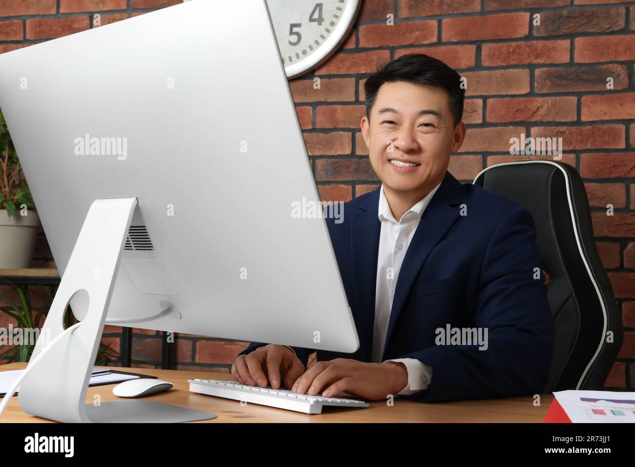 Happy boss working in his modern office Stock Photo - Alamy