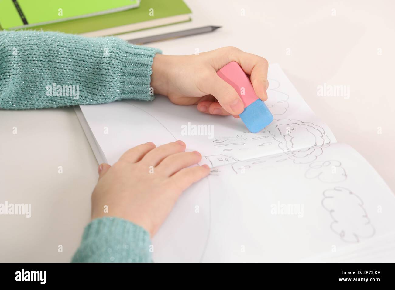 Girl erasing drawing in hi-res stock photography and images - Alamy