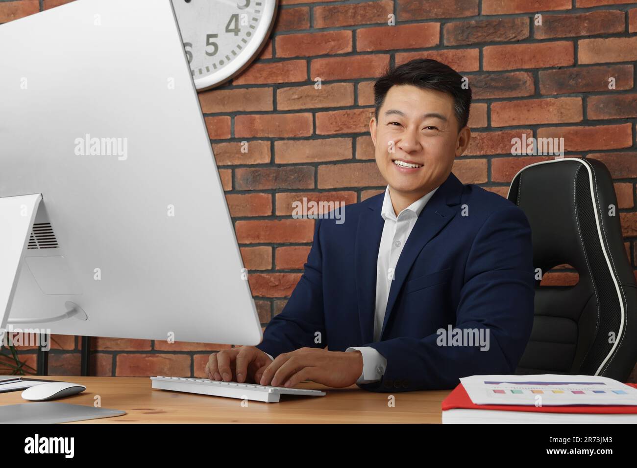 Happy boss working in his modern office Stock Photo - Alamy