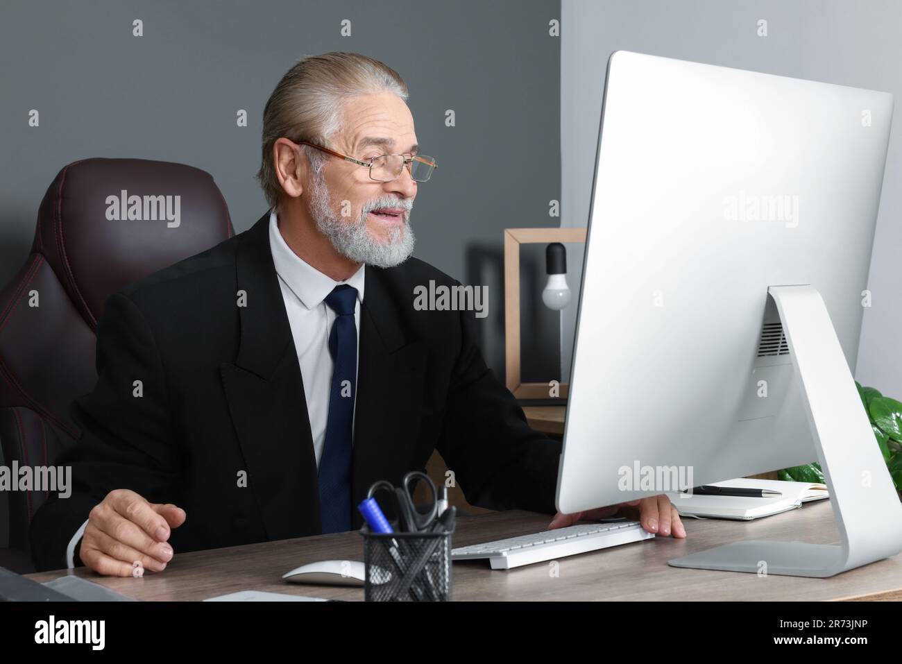 Successful senior boss working in his office Stock Photo - Alamy