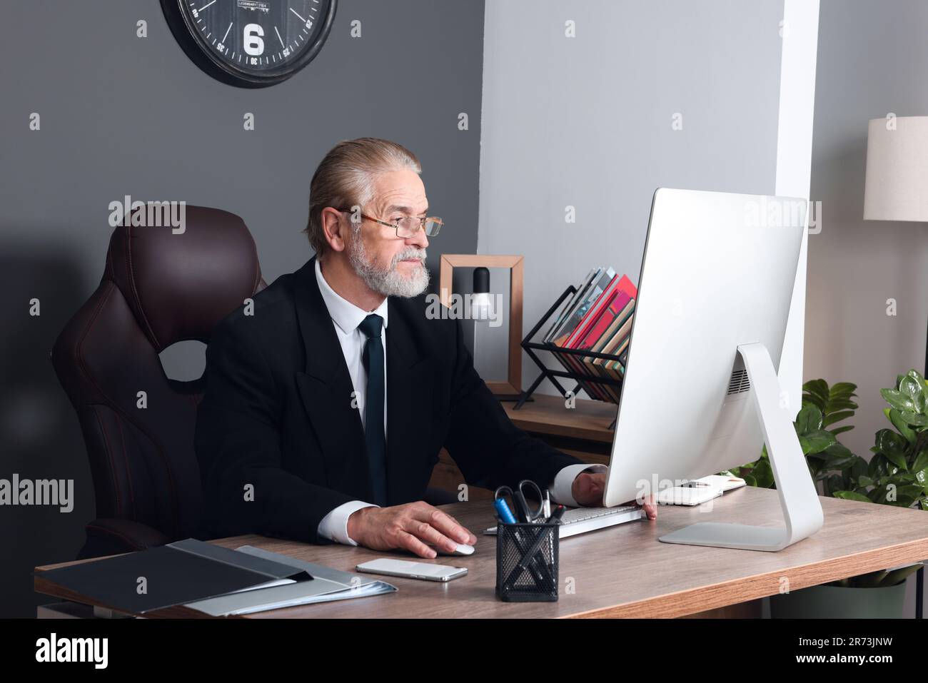 Successful senior boss working in his office Stock Photo - Alamy