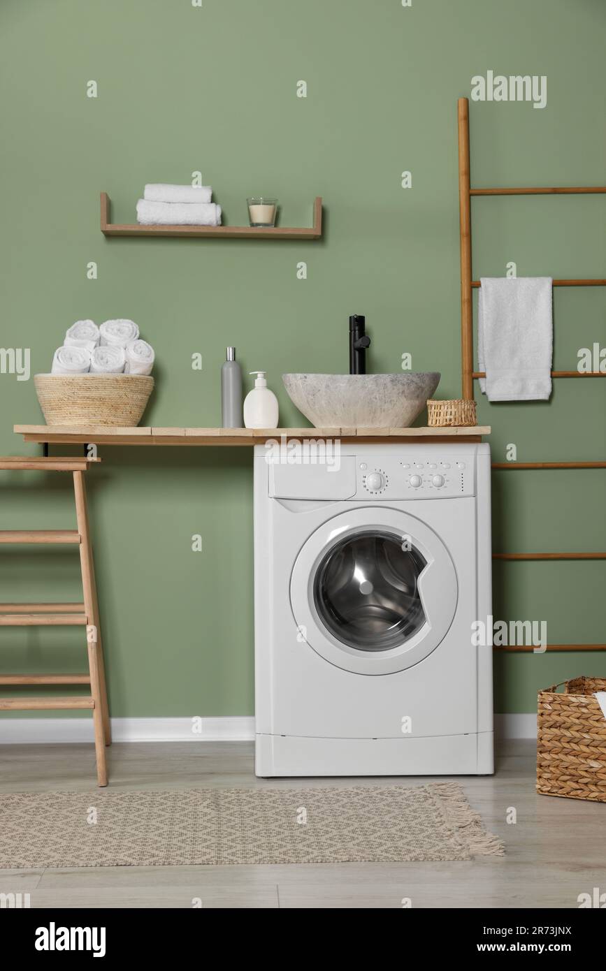 Stylish laundry room with functional washing machine. Interior design ...