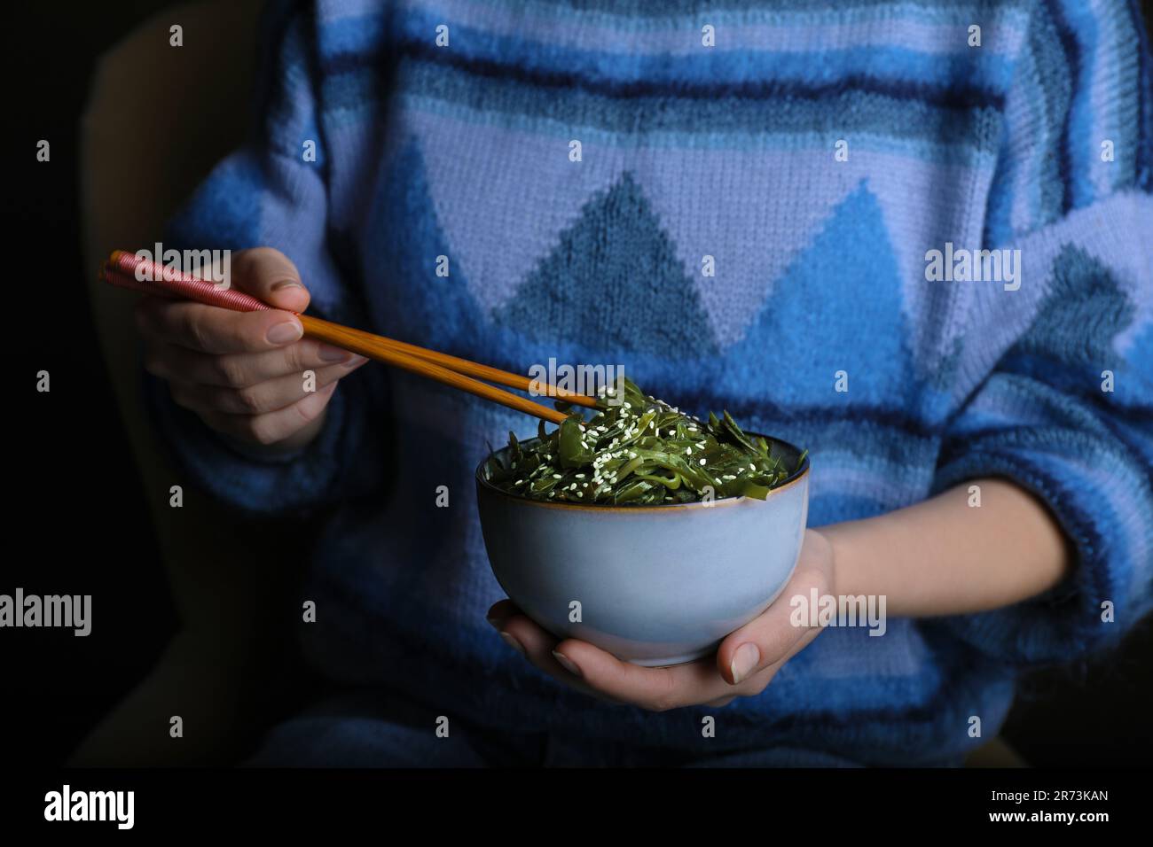 Woman eating fresh laminaria (kelp) seaweed, closeup Stock Photo - Alamy