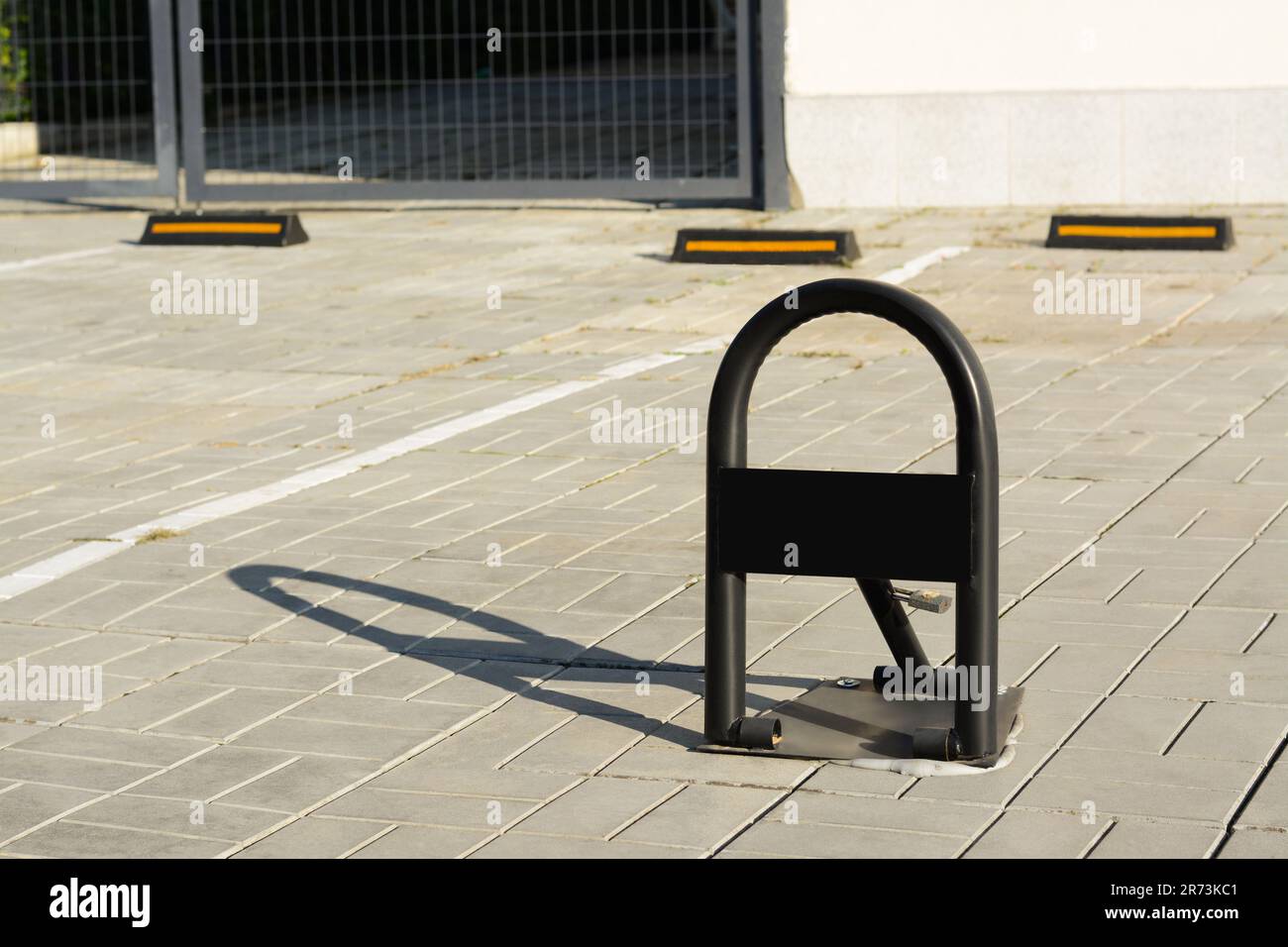 Parking barrier with No Stopping road sign on pavement outdoors, space ...