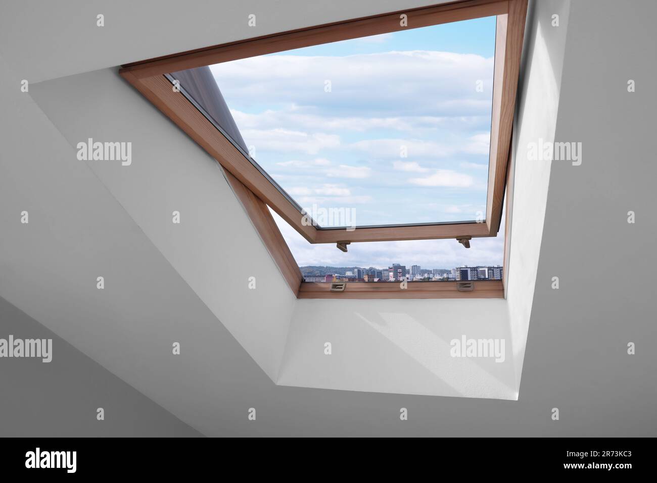 Open skylight roof window on slanted ceiling in attic room Stock Photo - Alamy