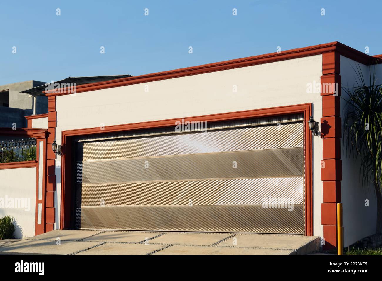 Garage building with closed sectional metal gate Stock Photo - Alamy