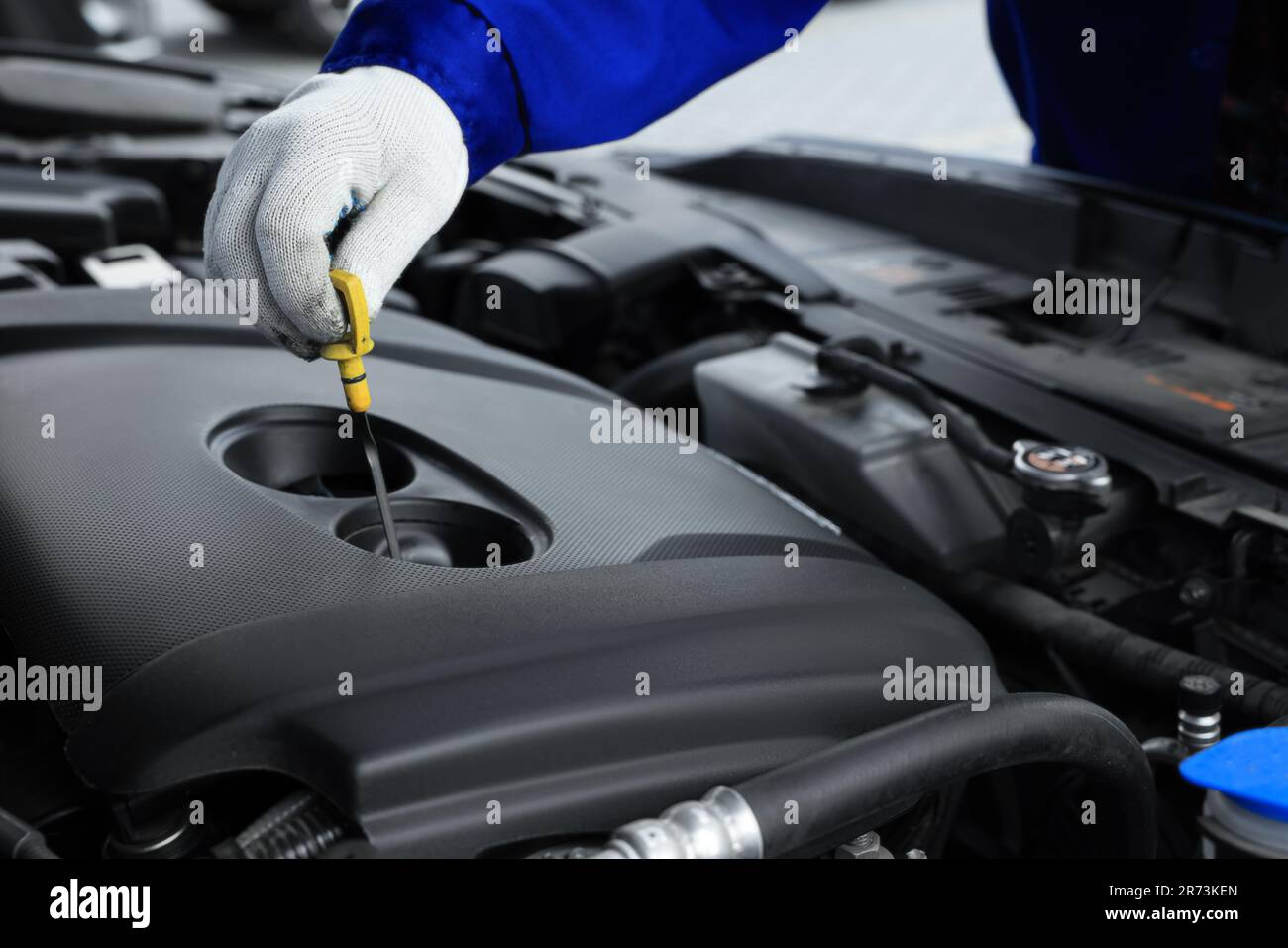 Worker checking motor oil level in car with dipstick, closeup Stock ...