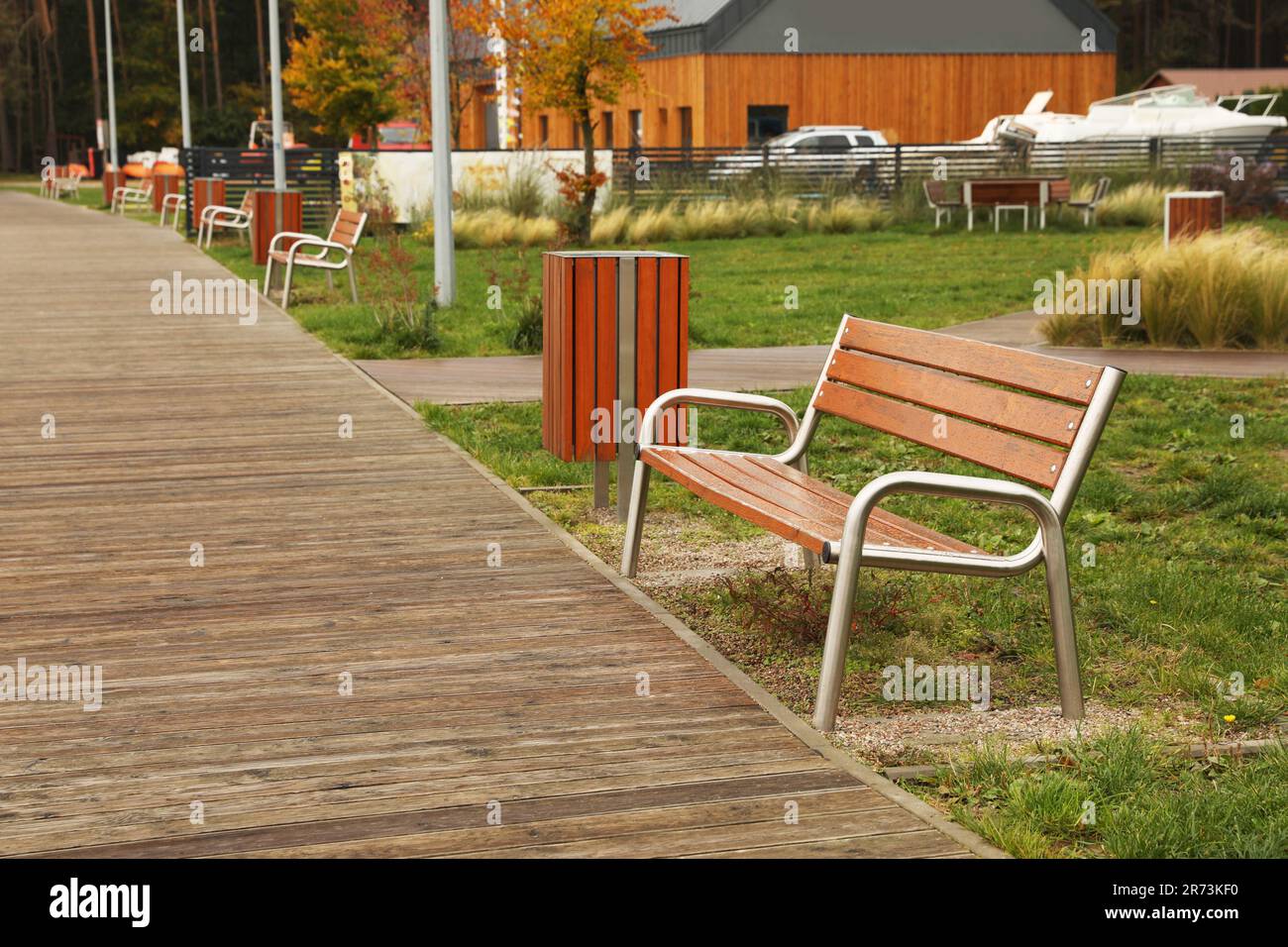 Wooden benches near pathway outdoors. Real estate Stock Photo - Alamy