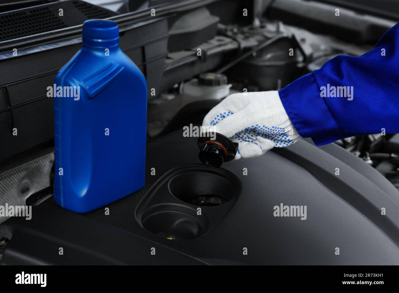 Worker checking motor oil level in car, closeup Stock Photo - Alamy