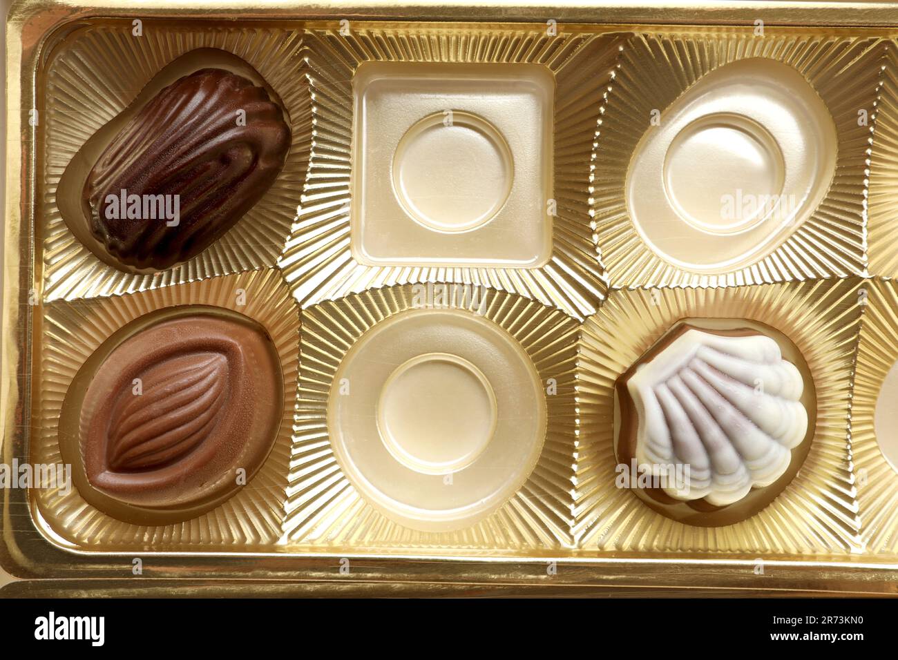 Partially empty box of chocolate candies as background, top view Stock ...