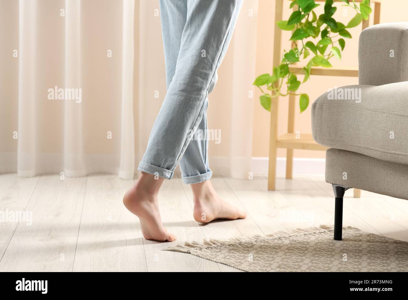 Woman stepping barefoot in room at home, closeup. Floor heating Stock ...