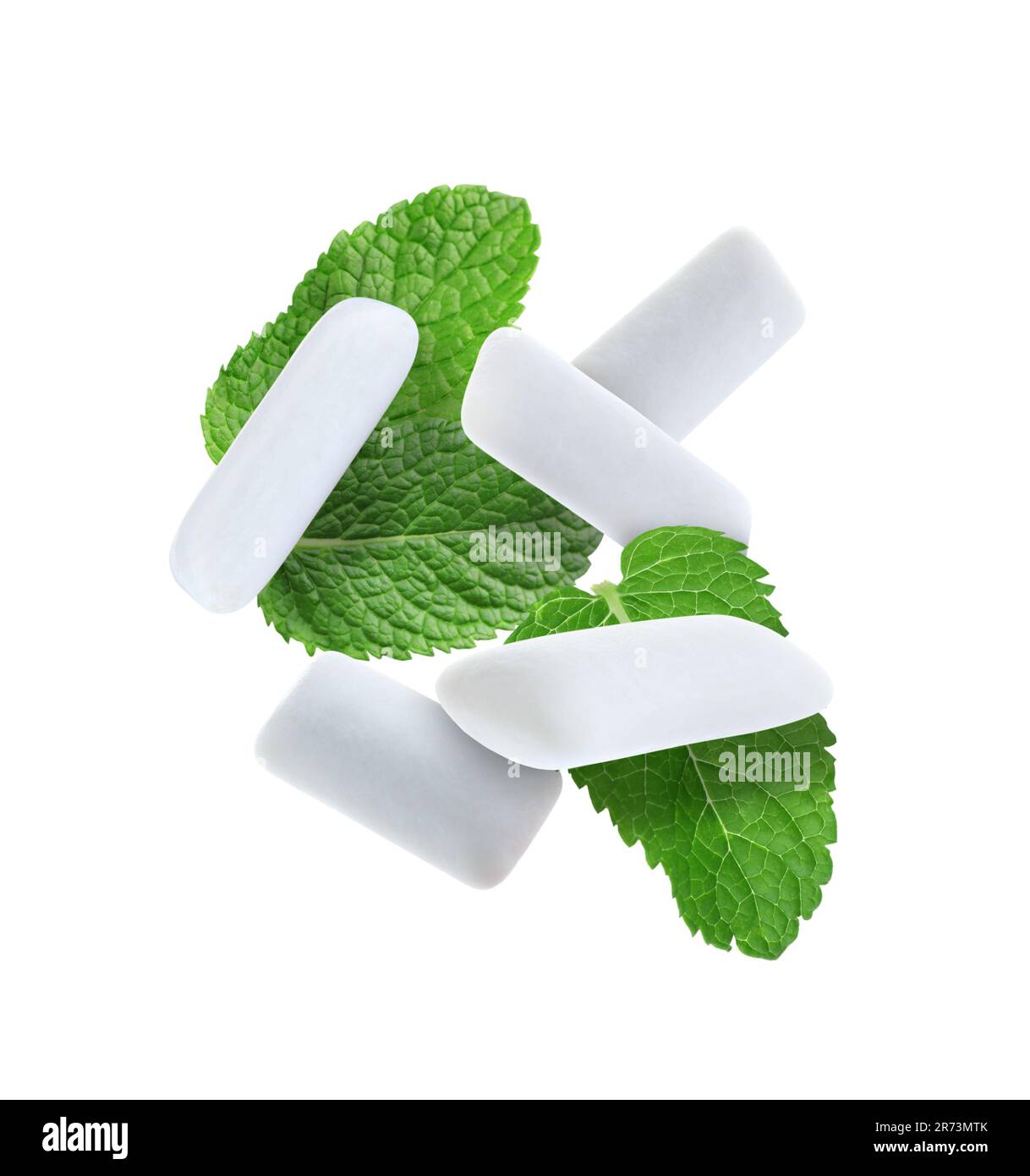 Fresh mint leaves and chewing gum pads falling on white background ...