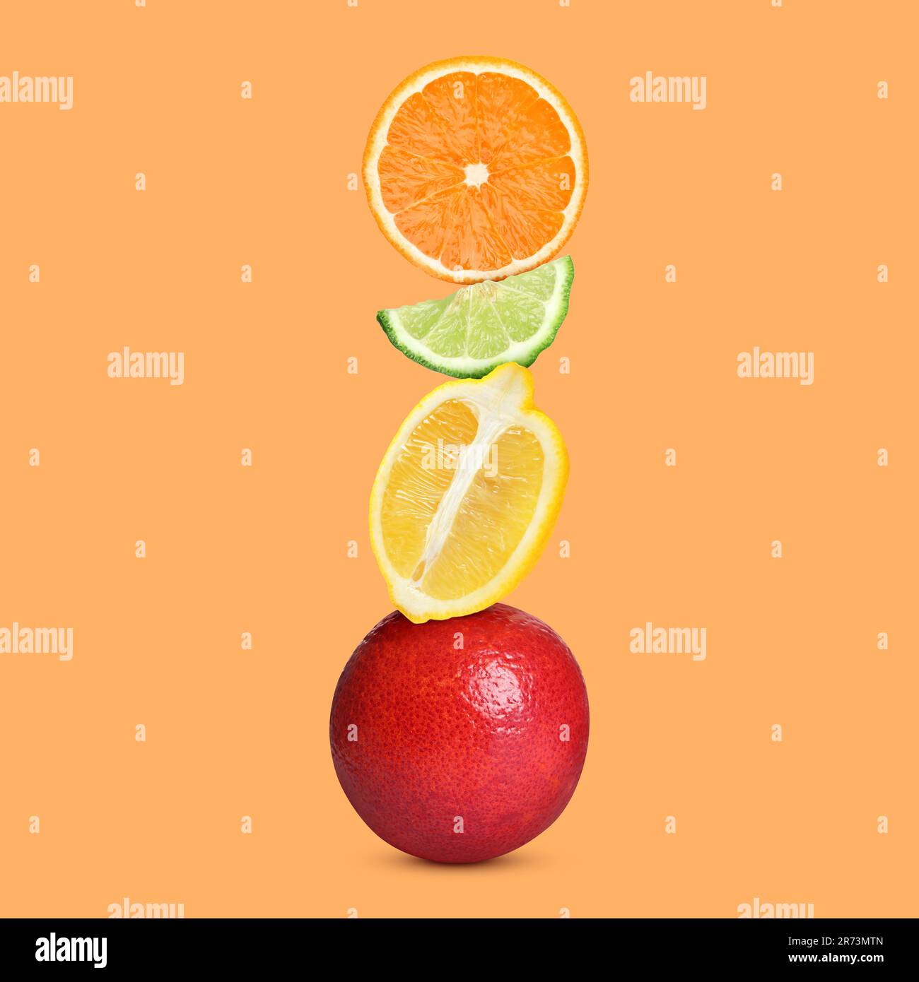 Stack of different fresh citrus fruits on pale orange background Stock ...