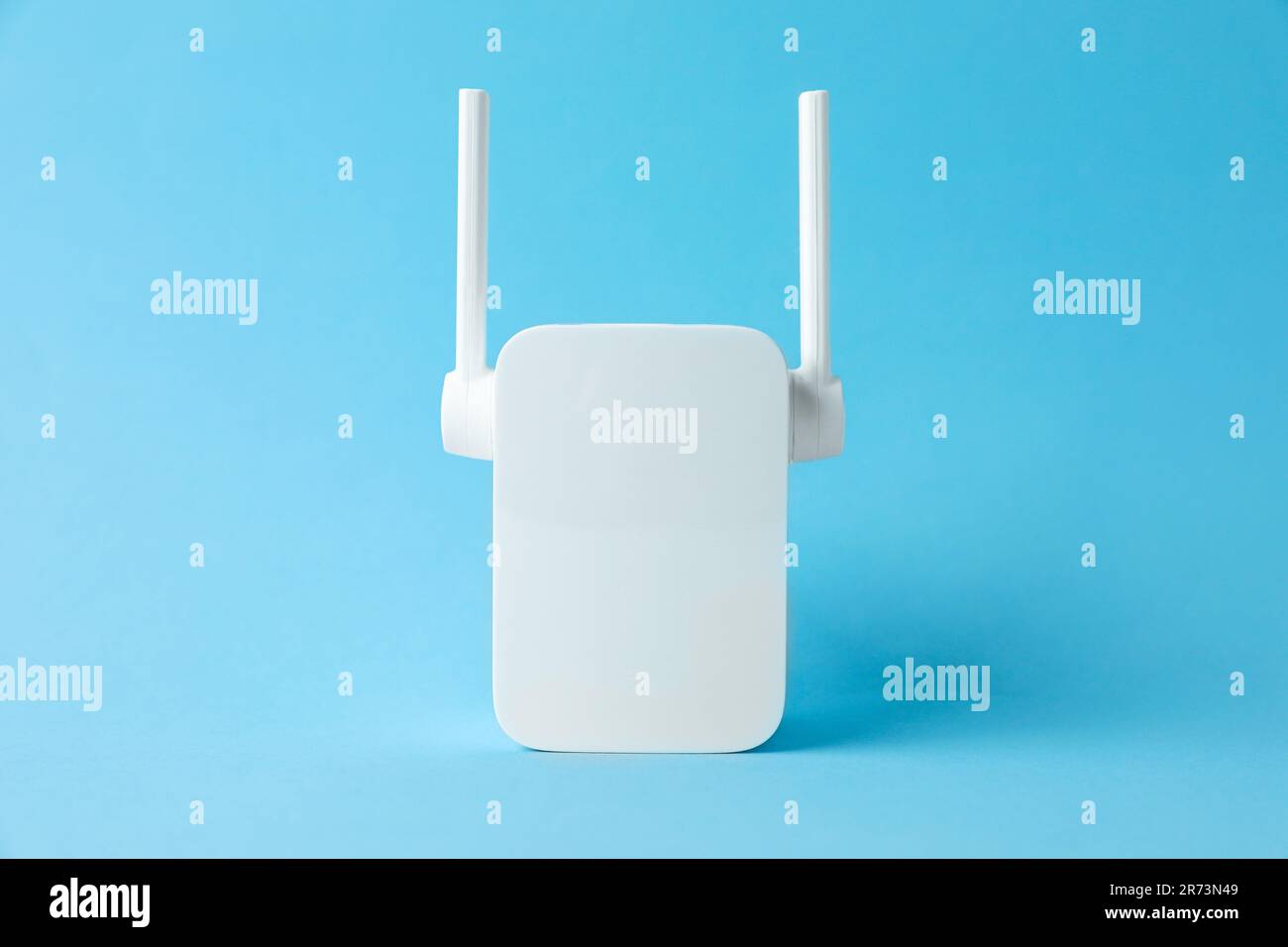 New modern Wi-Fi repeater on light blue background Stock Photo - Alamy