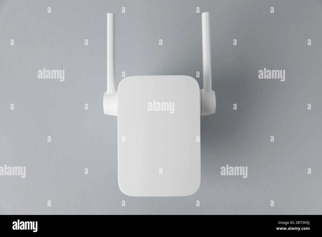 New modern Wi-Fi repeater on light gray background Stock Photo - Alamy