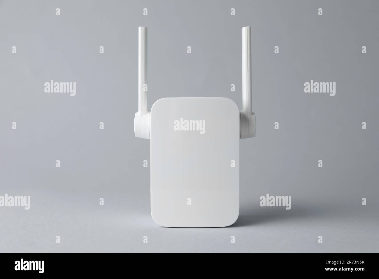 New modern Wi-Fi repeater on light gray background Stock Photo - Alamy