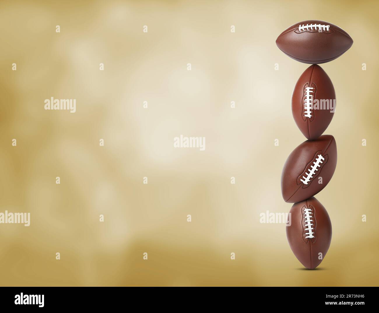 Stack of American football balls on gold background. Space for text ...