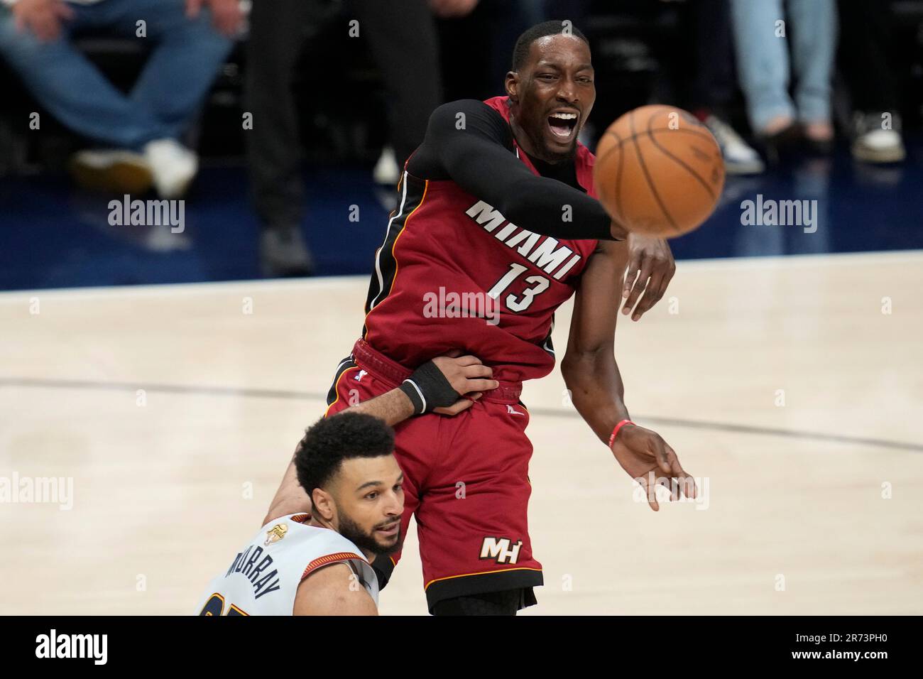 Miami Heat center Bam Adebayo (13) passes the ball while defended by ...